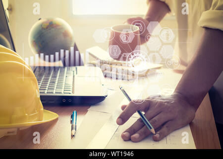 Digital icons and man with cup of coffee and mobile phone near window ...