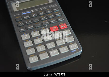 A gray calculator made of quality plastic with beautiful colors located ...