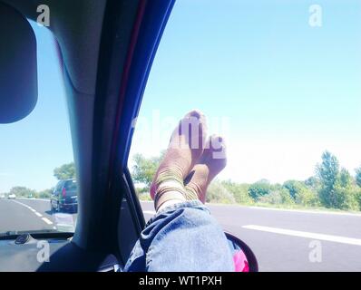 Woman legs out of the car window. Travel and fun Stock Photo - Alamy
