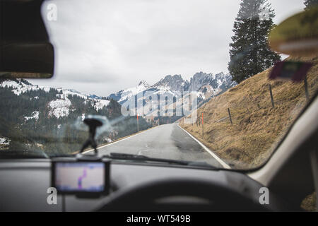 view through car windshield to snow-covered road Stock Photo - Alamy