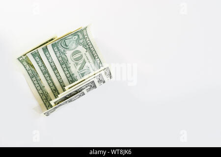 Slightly curled one-dollar bills on a light background Stock Photo - Alamy
