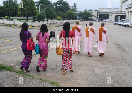 Buddhist nuns and pedestrians walk on a road Sunday, Feb. 1, 2026, in ...