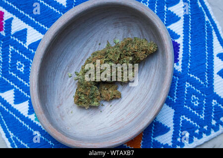 Marijuana in Clay Bowl on Blue Textile in Mexico Stock Photo - Alamy