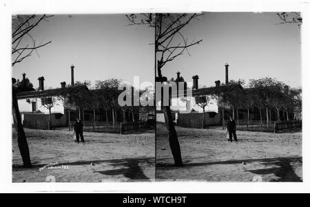 Mikweh. Boy and shy girl in front of building American Colony ...