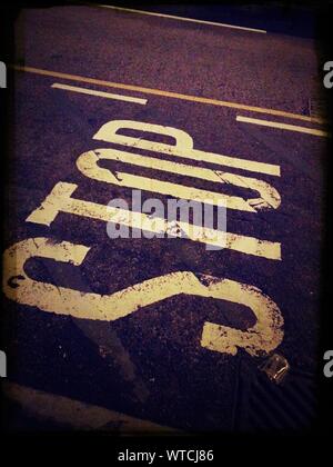 A stop sign painted on the road at a junction in the Peak District ...