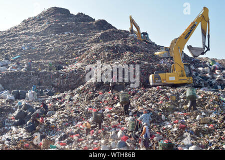Scavengers sort and collect plastics for recycling at the garbage ...