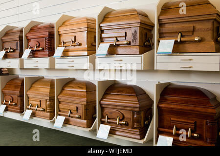 Wooden coffins on display in a showroom, show room Stock Photo - Alamy