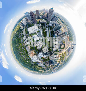tiny planet in sky with clouds overlooking above on empty stadium or ...