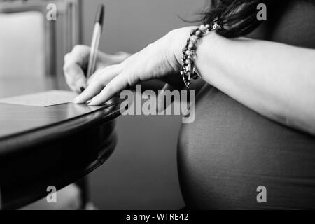 Pregnant Woman Writing On Her Belly Stock Photo - Alamy