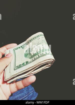 Man holding twenty dollar bills Stock Photo - Alamy