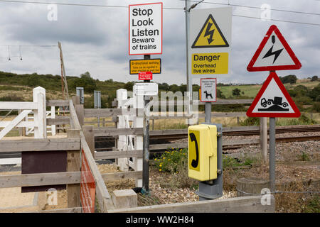 Signs 'Stop Look Listen', 'Beware of trains' and 'Warning do not Stock ...