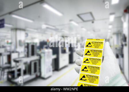 Hand holding "CAUTION Electrostatic Sensitive Devices" label at static ...