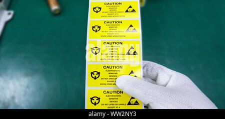 Hand holding ESD symbol label with antistatic gloves,Electrostatic ...