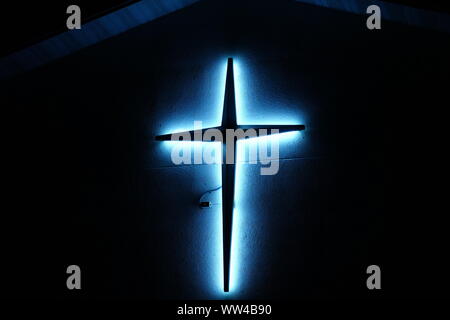Beautiful Bright Neon Blue Cross on Side of a church building in ...