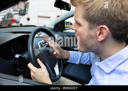 Male hand honking the car horn, man driving vehicle and beeping Stock Photo - Alamy