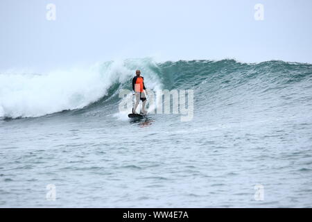 Free surf at Kuta reef Bali Stock Photo - Alamy