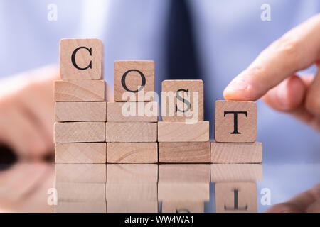 Spend Word And Man Pushing Down Chart Stock Photo - Alamy