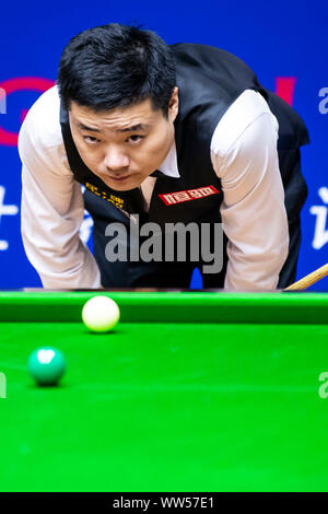 Chinese professional snooker player Ding Junhui plays a shot at the ...