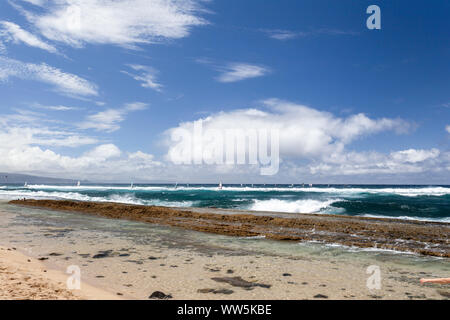 USA, Hawaii, Maui. Wind surfer get air on monster wave at Pe'ahi Jaws ...