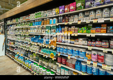 Vitamin and herbal supplement display shelves in a health food store ...