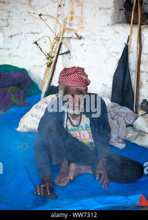 Oromo man with a forked stick in Sheikh Hussein shrine, Oromia, Sheik ...