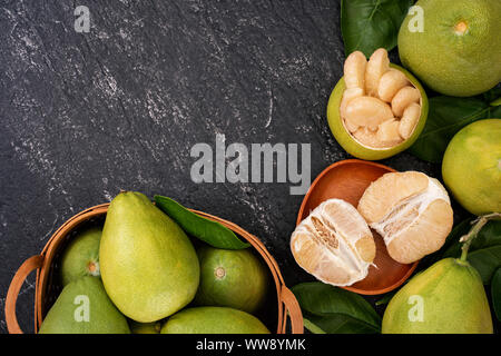Fresh pomelo, pummelo, grapefruit, shaddock on black background, fruit ...