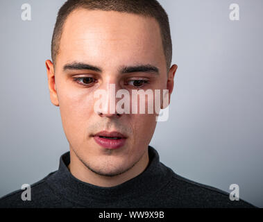Unhappy crying young man with dropping tears on the face. Closeup ...