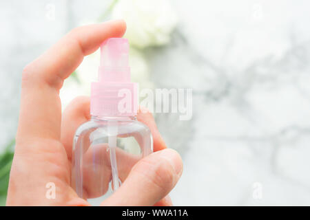 Woman's perfume spray from hand on black background Stock Photo - Alamy
