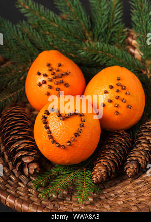 christmas composition in basket with oranges and fir tree, on wooden ...