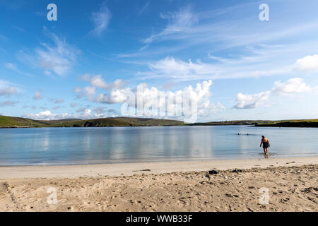 Woman entering in the sea in Levenwick Beach, Mainland, Shetland ...