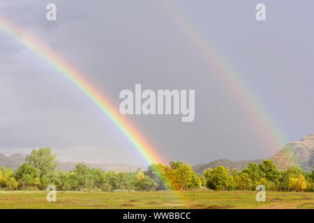 Receding storm clouds and a rainbow, Theodore Roosevelt National Park ...