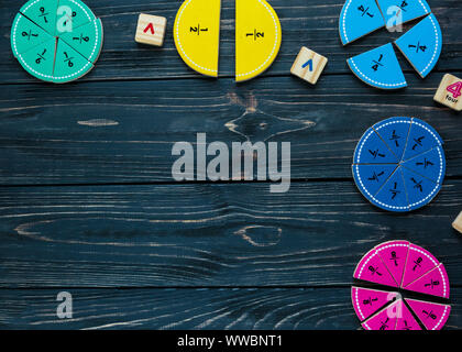 Colorful math fractions on wooden background or table. interesting math ...