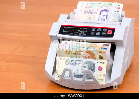 Uruguayan money - peso in the counting machine Stock Photo - Alamy