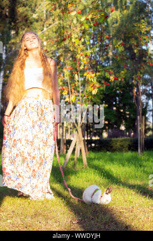 girl with a rabbit on a leash walk park care pet Stock Photo - Alamy