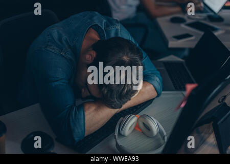 Young programmer sleeping in office at night Stock Photo - Alamy