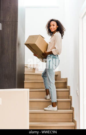 Young african american woman moving to a new home choosing colors ...