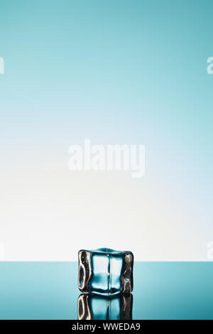 transparent ice cube on emerald and white background Stock Photo - Alamy