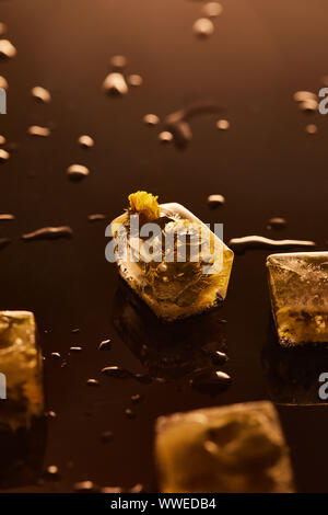 Ice cubes with water drops scattered on a blue background, top view ...