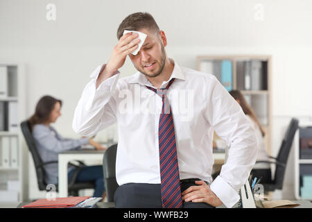 Businessman having panic attack in office Stock Photo - Alamy