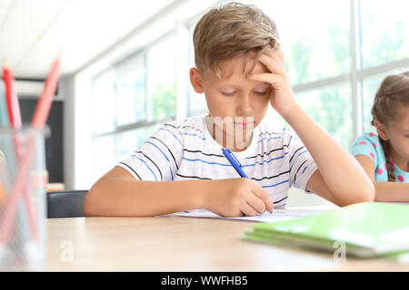 Boy passing difficult school test in classroom Stock Photo - Alamy