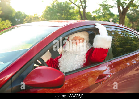 Portrait of Santa Claus. Santa Claus is driving his red car Stock Photo ...