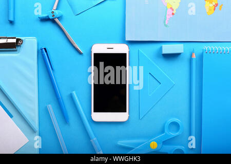 Modern mobile phone with map and stationery on color background Stock ...