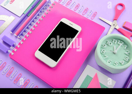 Mobile phone with stationery, many business documents and graphics on ...