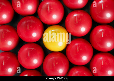 Alone billiard one yellow ball between many red balls background ...