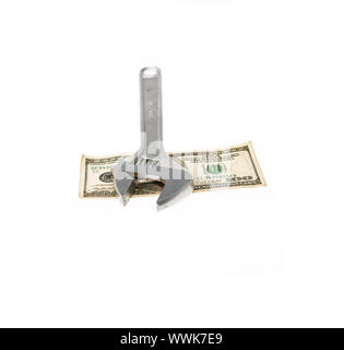 wrench tool fixing dollar bill isolated on white background closeup ...