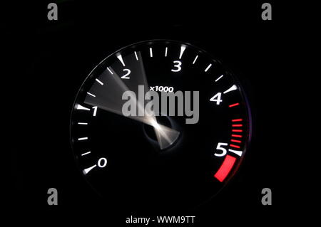 moving revs meter of a sports car on a black background Stock Photo - Alamy
