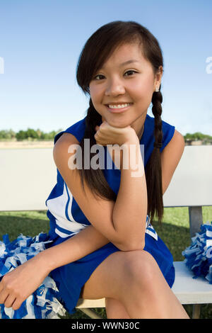Cheerleaders on bleachers Stock Photo - Alamy