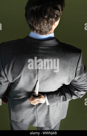 dangerous businessman hiding knife behind his back while handshaking ...