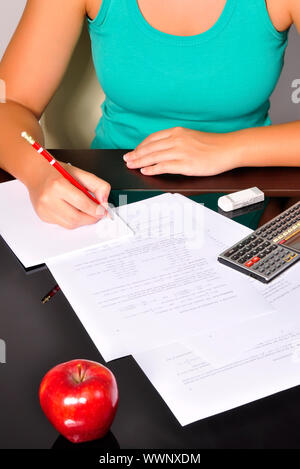Student doing maths exercices with a calculator and a red pencil Stock ...