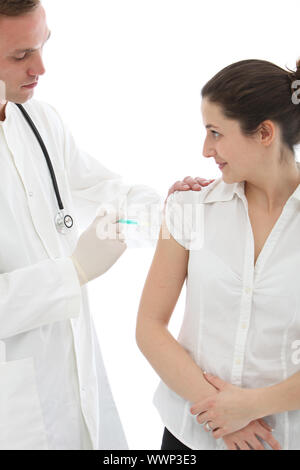 Doctor administering intramuscular injection in upper arm of female ...